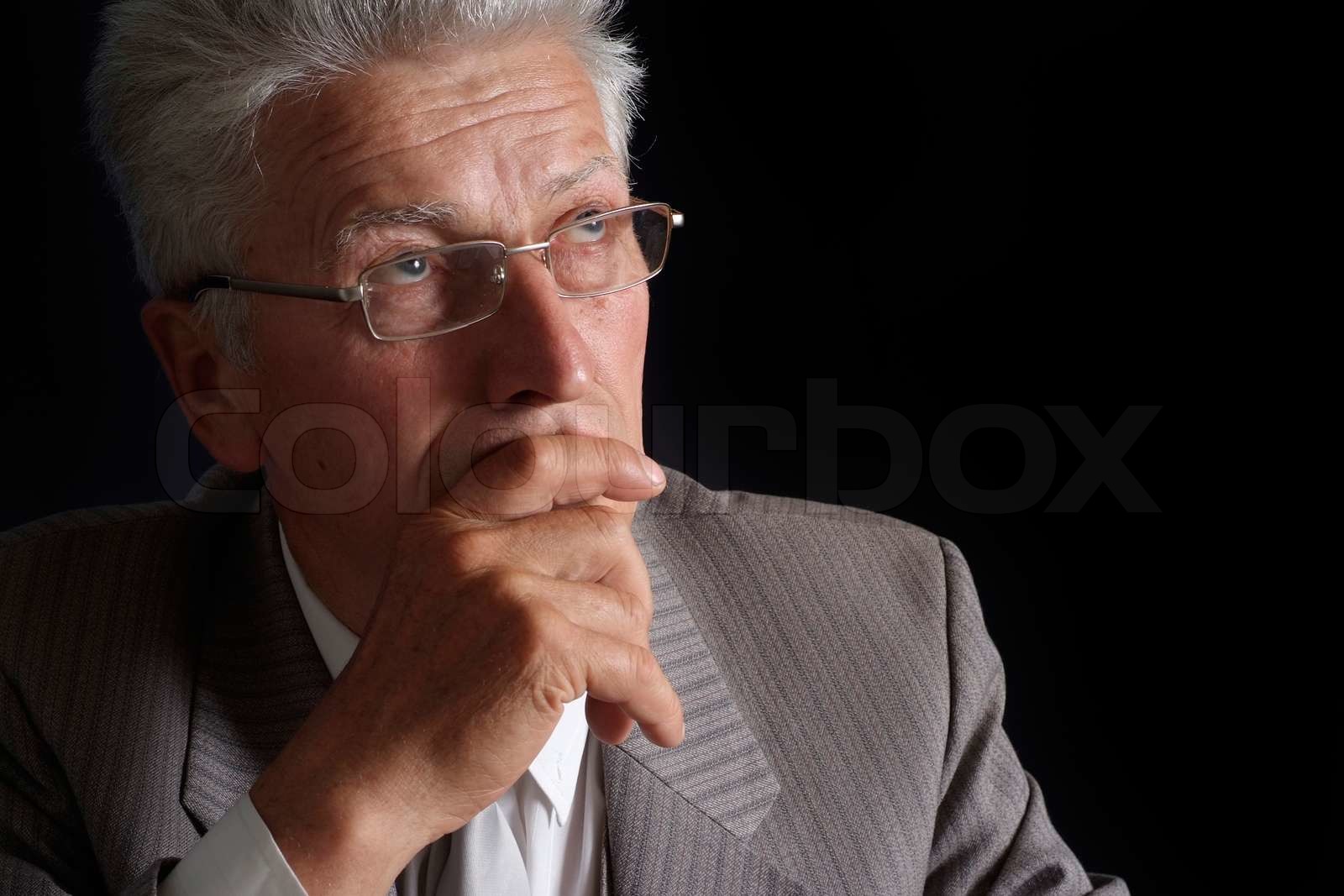 Thinking old man in suit | Stock image | Colourbox