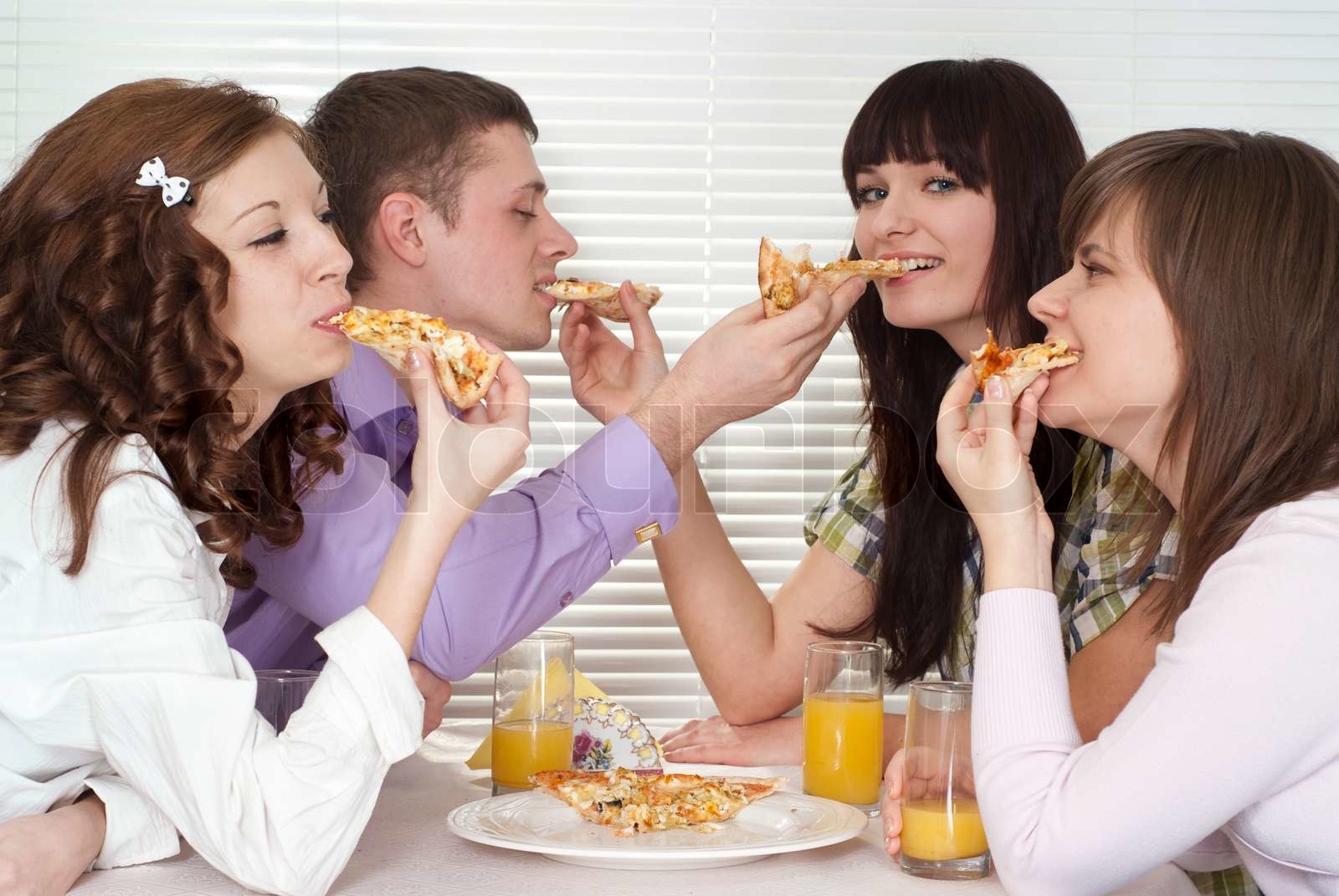 Jocular young people eat the pizza | Stock image | Colourbox
