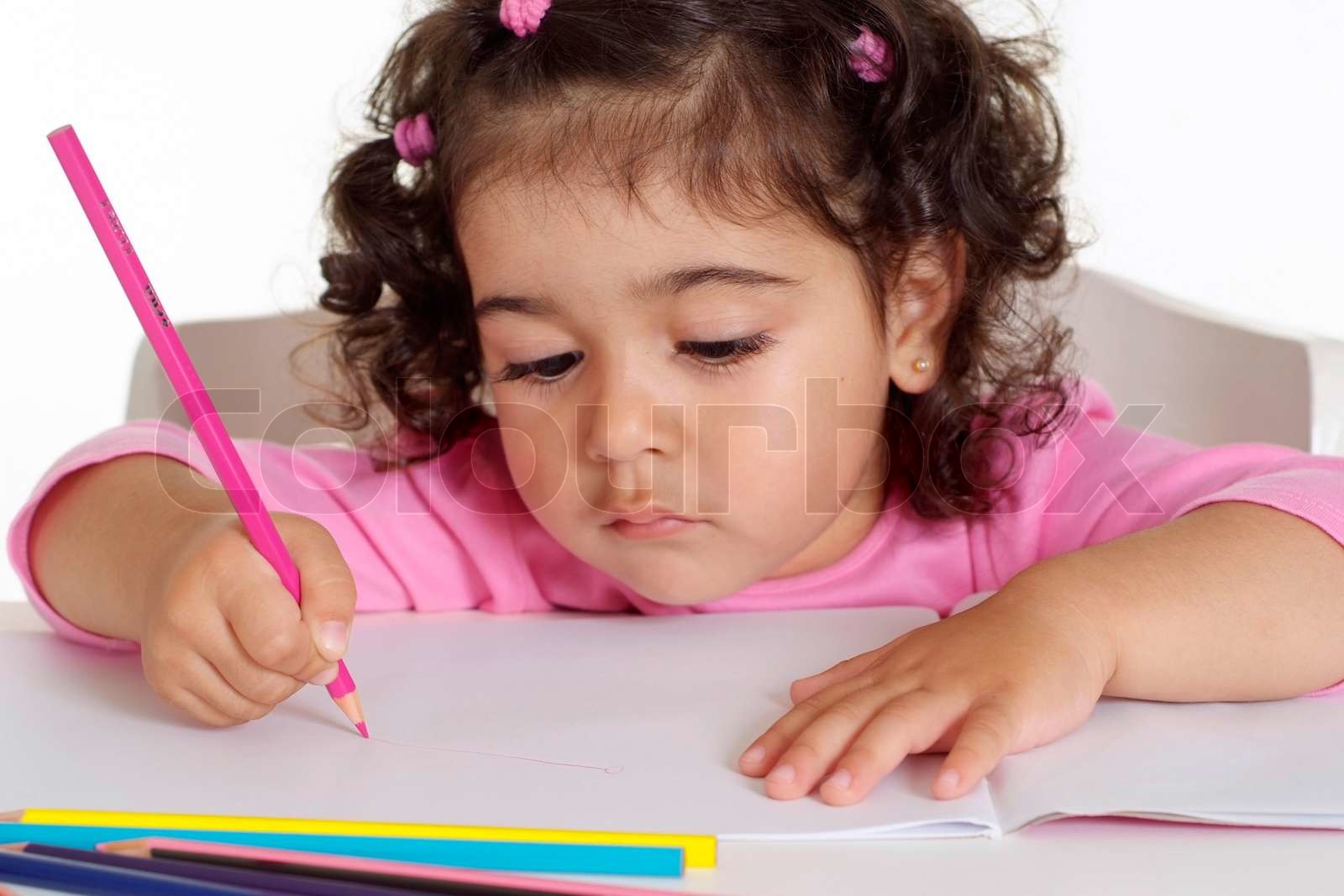 Good-looking little girl draws | Stock image | Colourbox