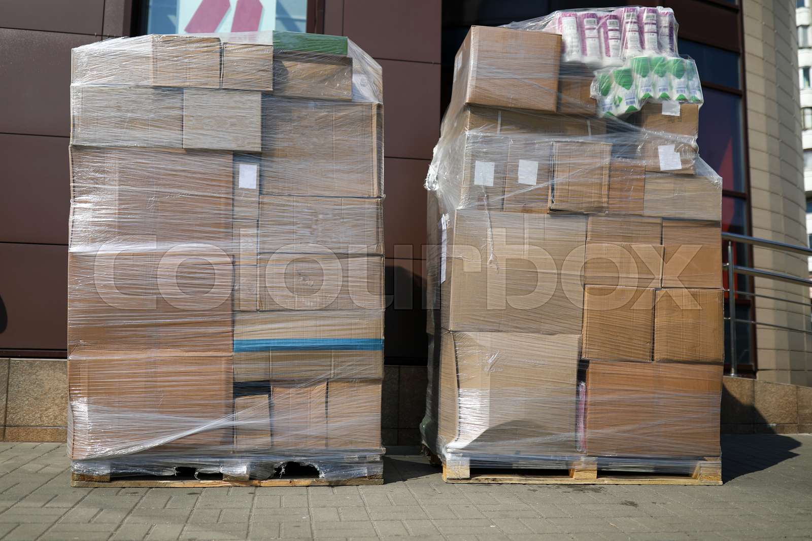 Huge pile of cardboard boxes packed together with stretch tape | Stock ...