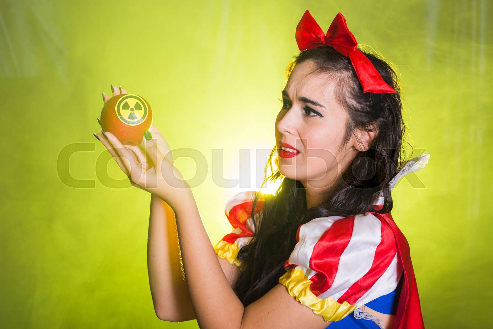 Woman holding hazardous radioactive apple. Nuclear and radiation ...