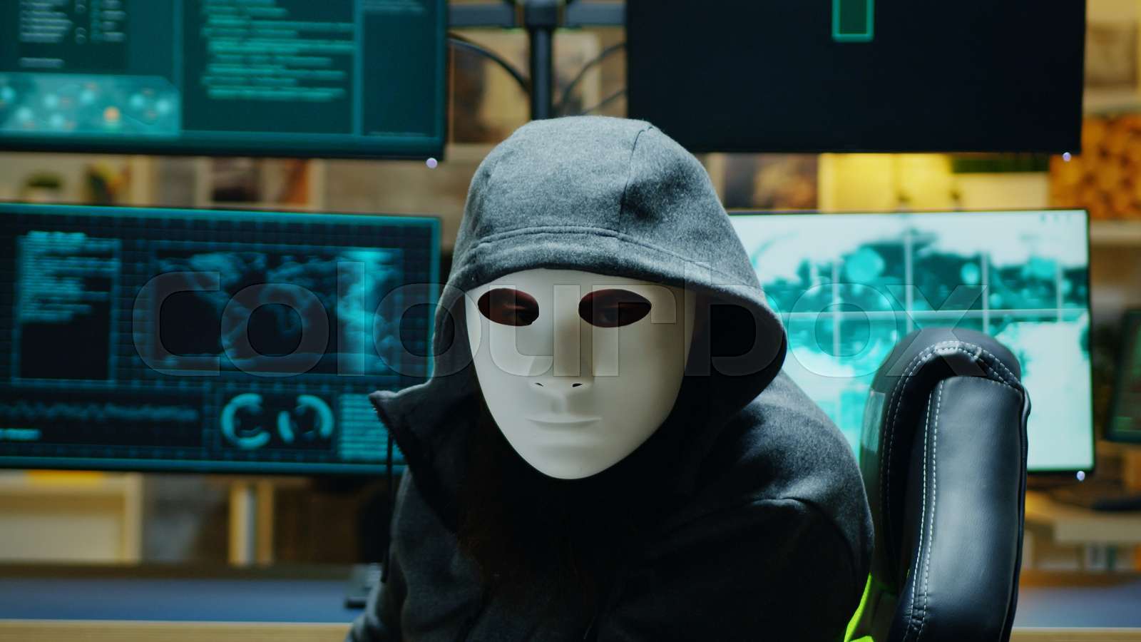 Masked hacker in his apartment looking into the camera | Stock image ...