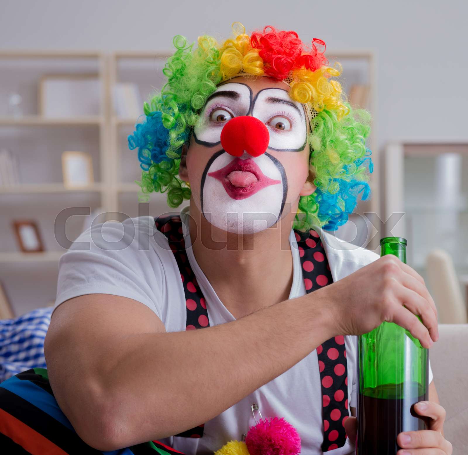 Drunk clown celebrating having a party at home | Stock image | Colourbox