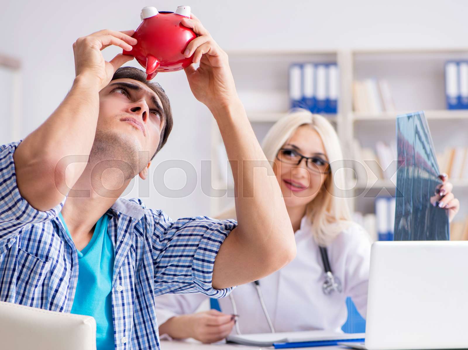 Male patient angry at expensive healthcare bill | Stock image | Colourbox