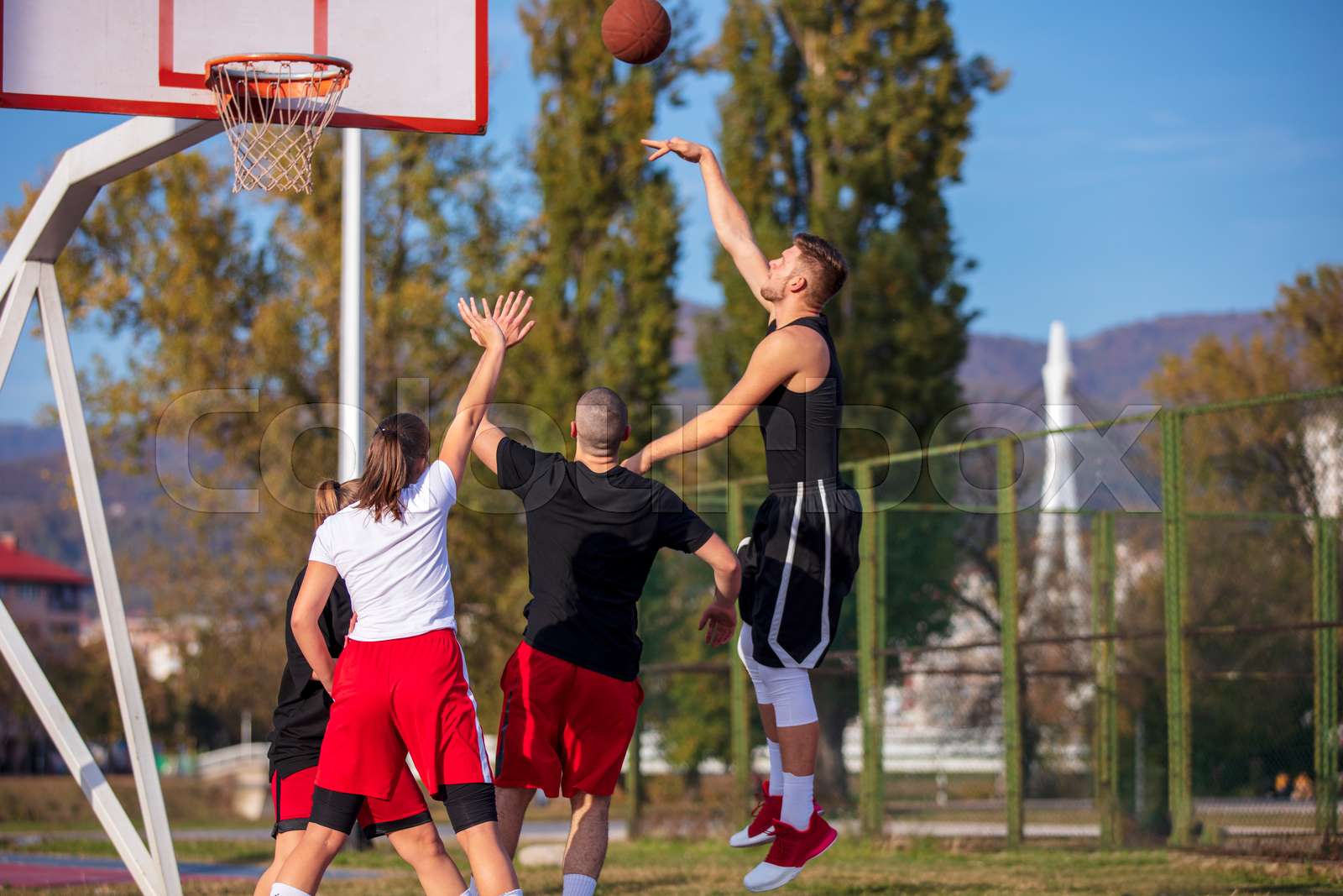 Group Of Young Friends Playing Basketball Match | Stock image | Colourbox