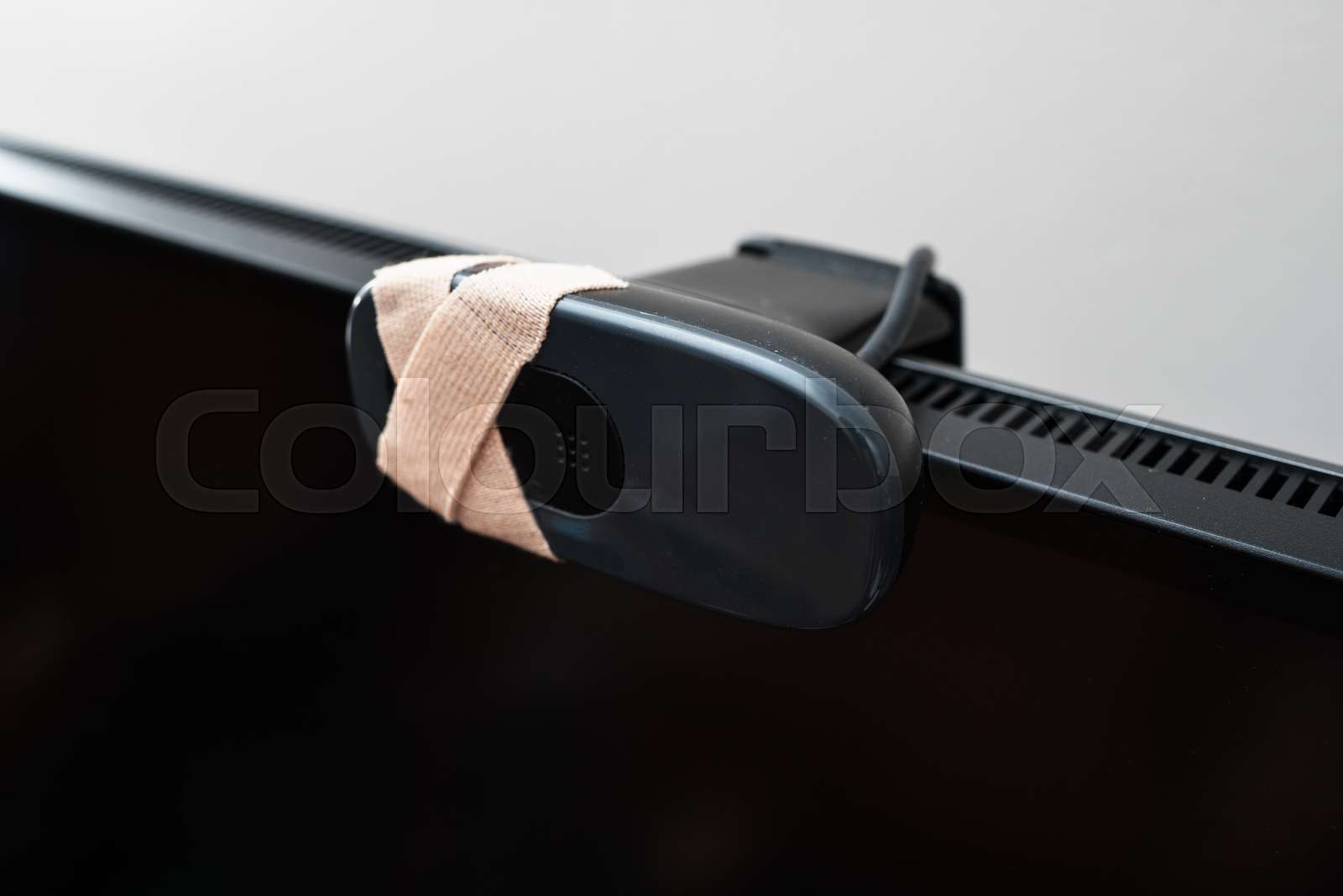 Close-up view of web camera covered with tape. | Stock image | Colourbox