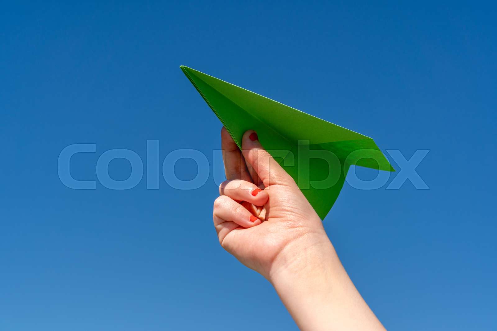 Paper plane in child hand | Stock image | Colourbox