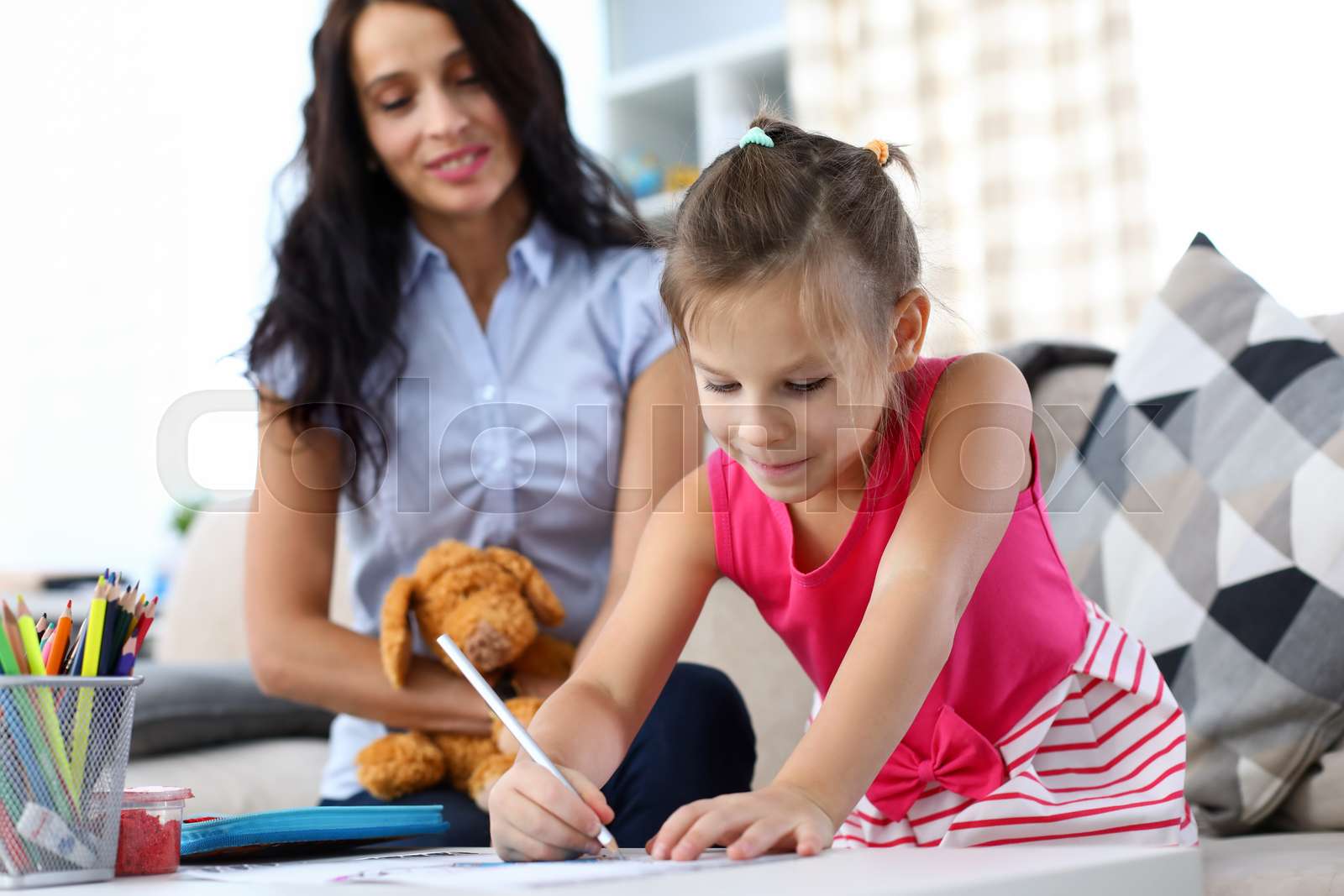 Mum teaching concentrated kid | Stock image | Colourbox