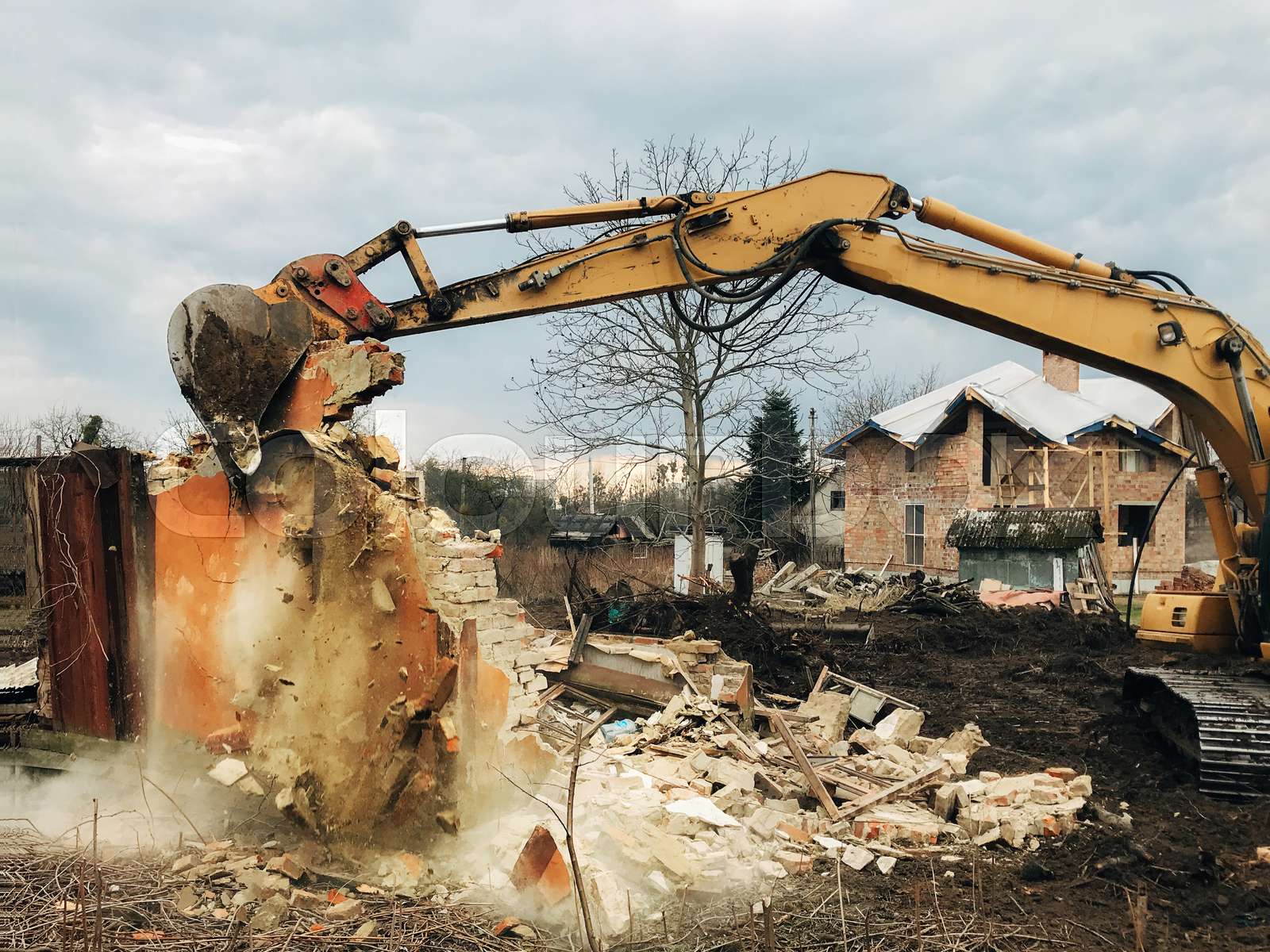 House crushing and collapse. Excavator destroying brick house on land ...