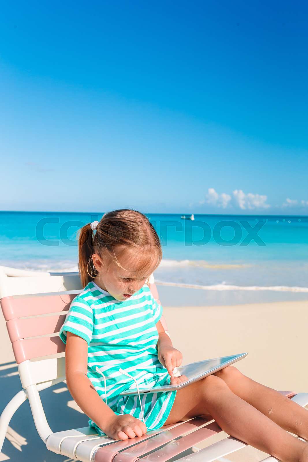 Little girl with laptop on beach during summer vacation | Stock image ...