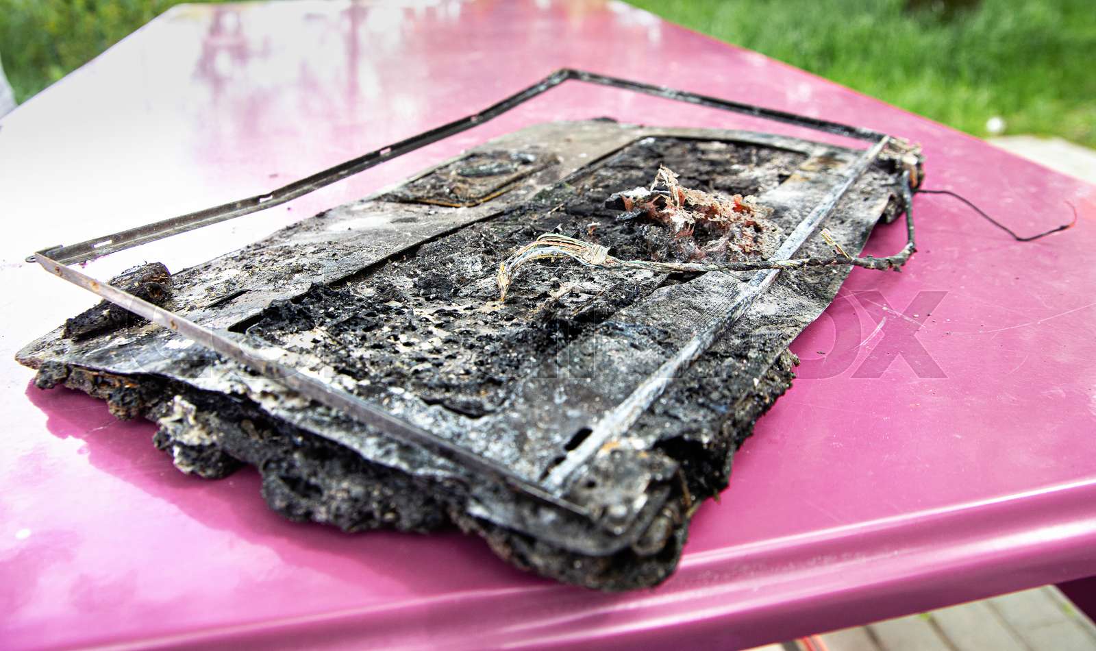 Broken laptop computer spoiled by flame melted plastic. Computer damage ...