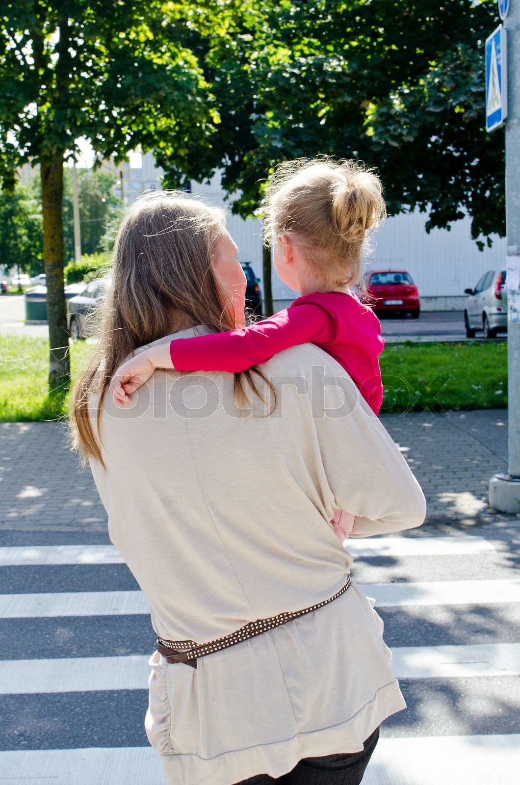 Mother and child crossing the road Back view | Stock image | Colourbox