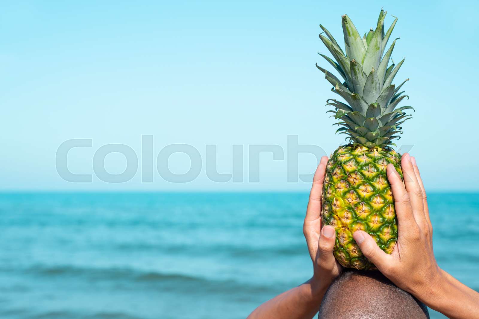 man with a pineapple on his head | Stock image | Colourbox