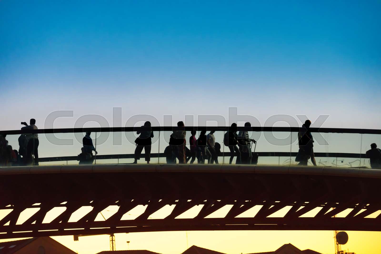 Silhouette of walking people on bridge | Stock image | Colourbox