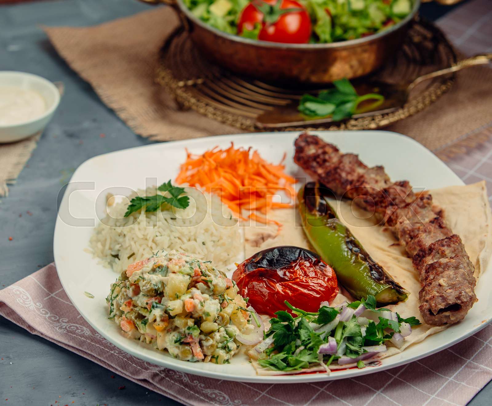 kebab with rice and vegetables in the plate on the table | Stock image ...