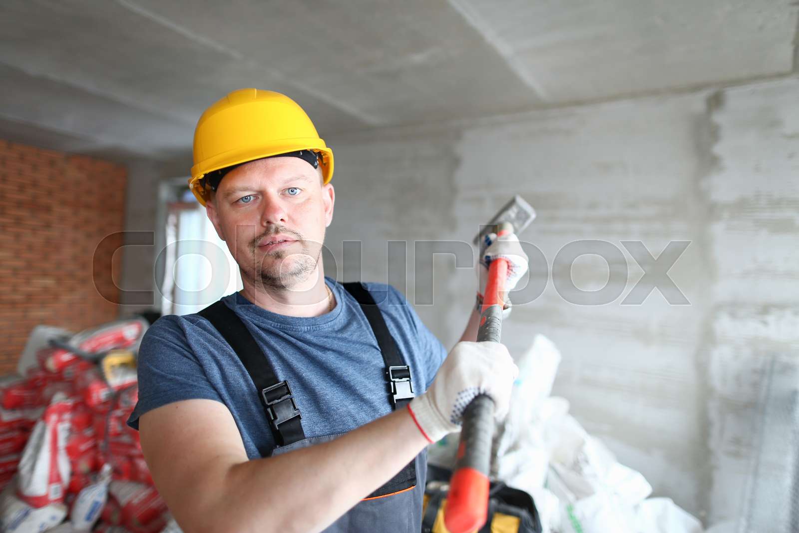 Real strong man working at building object | Stock image | Colourbox