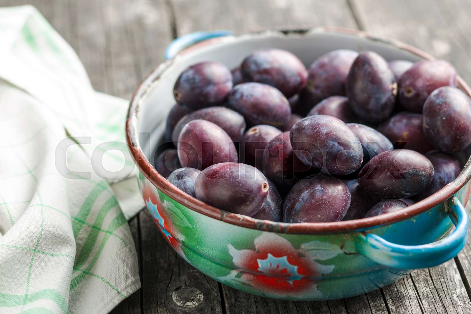 Fresh plums from garden in bowl. | Stock image | Colourbox