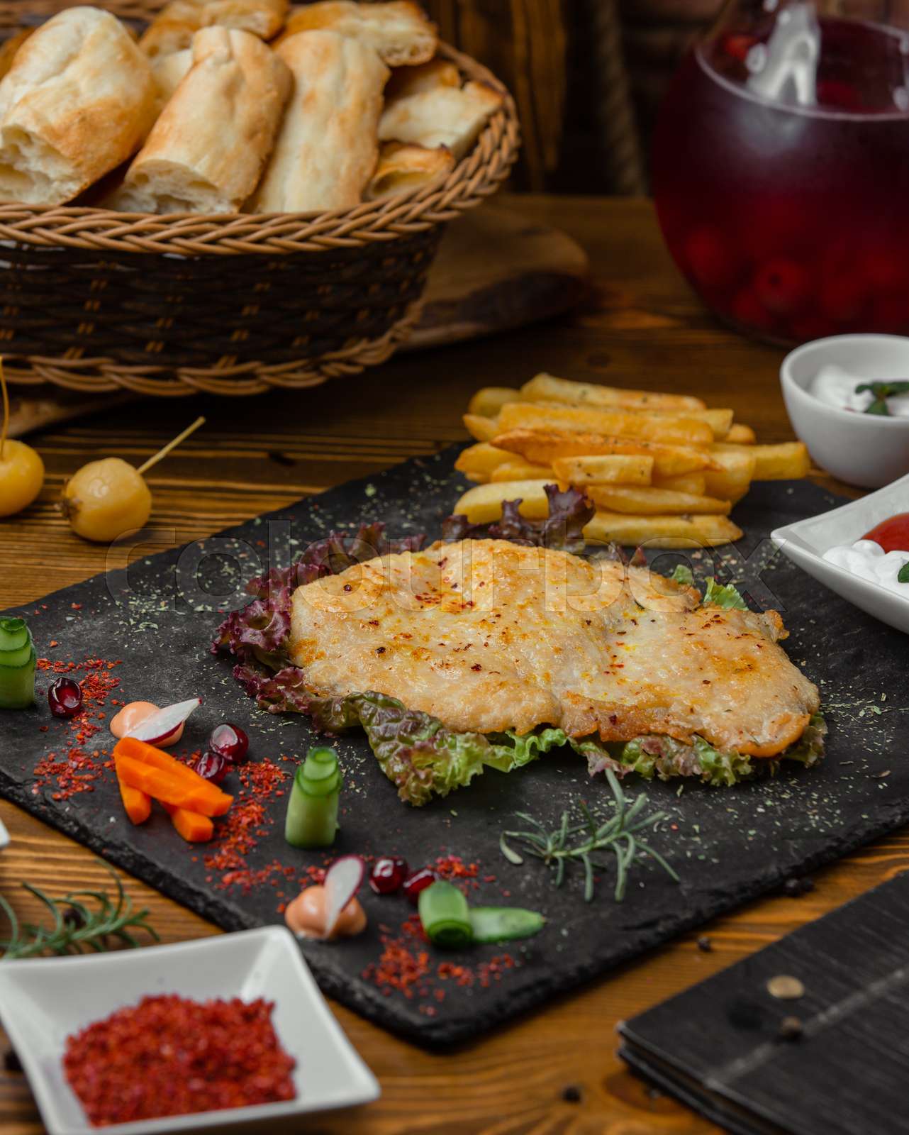 chicken langet served with fired potato and vegetables | Stock image ...