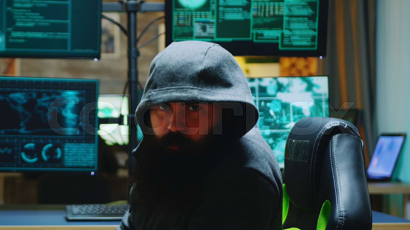 Dangerous hacker wearing a hoodies and looking into the camera | Stock ...