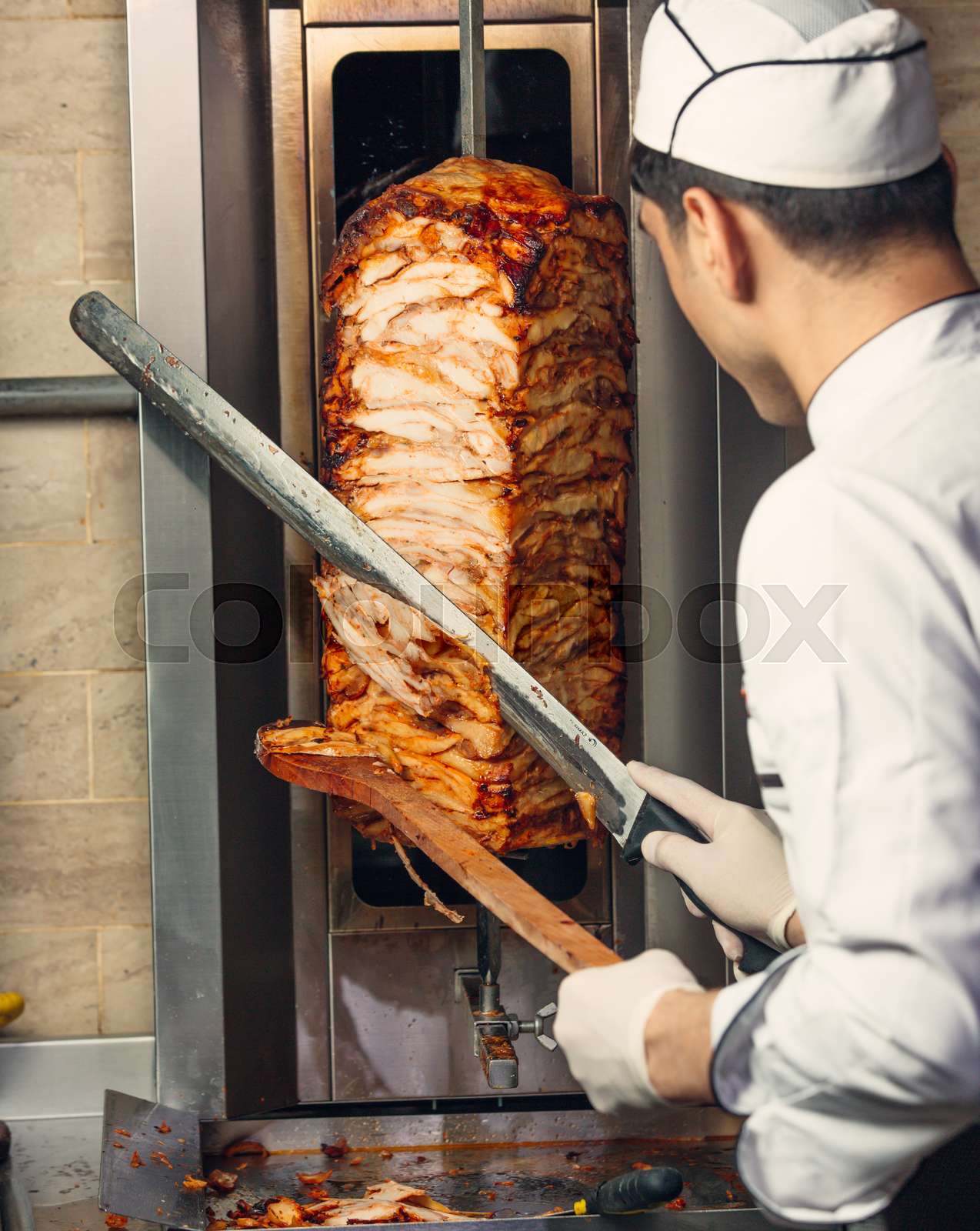 Man cutting doner in kebab shop with doner knife | Stock image | Colourbox
