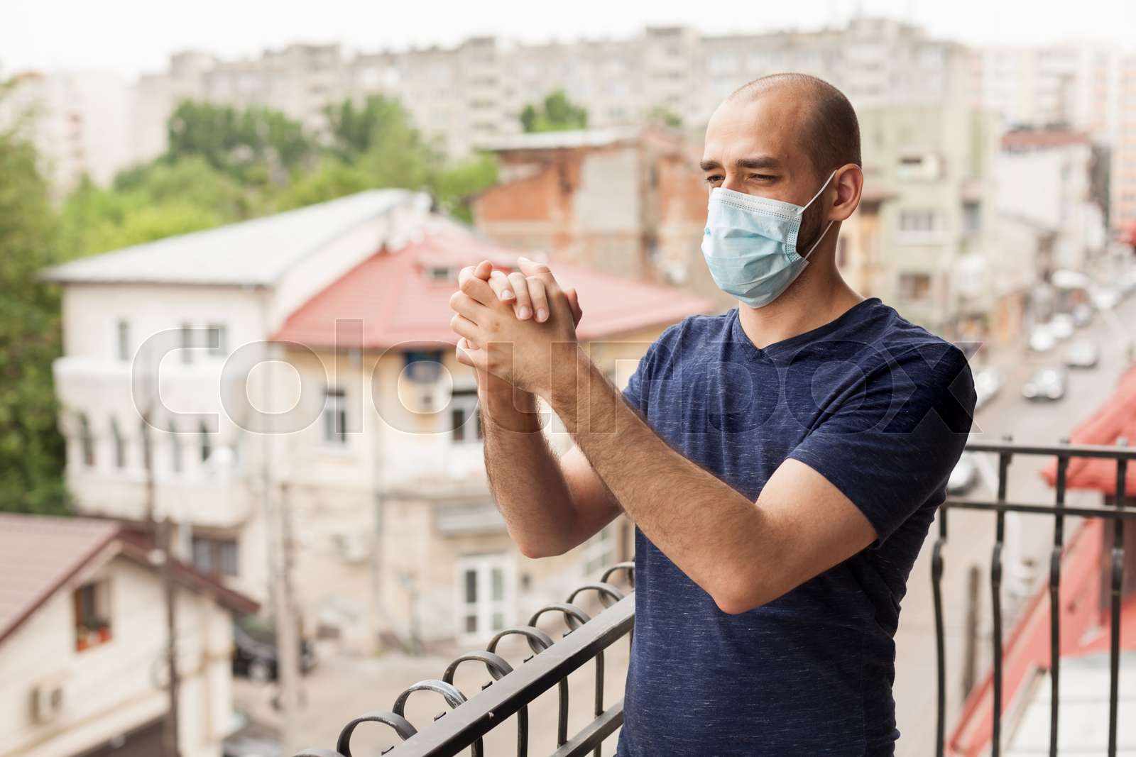 Happy man clapping on balcony | Stock image | Colourbox