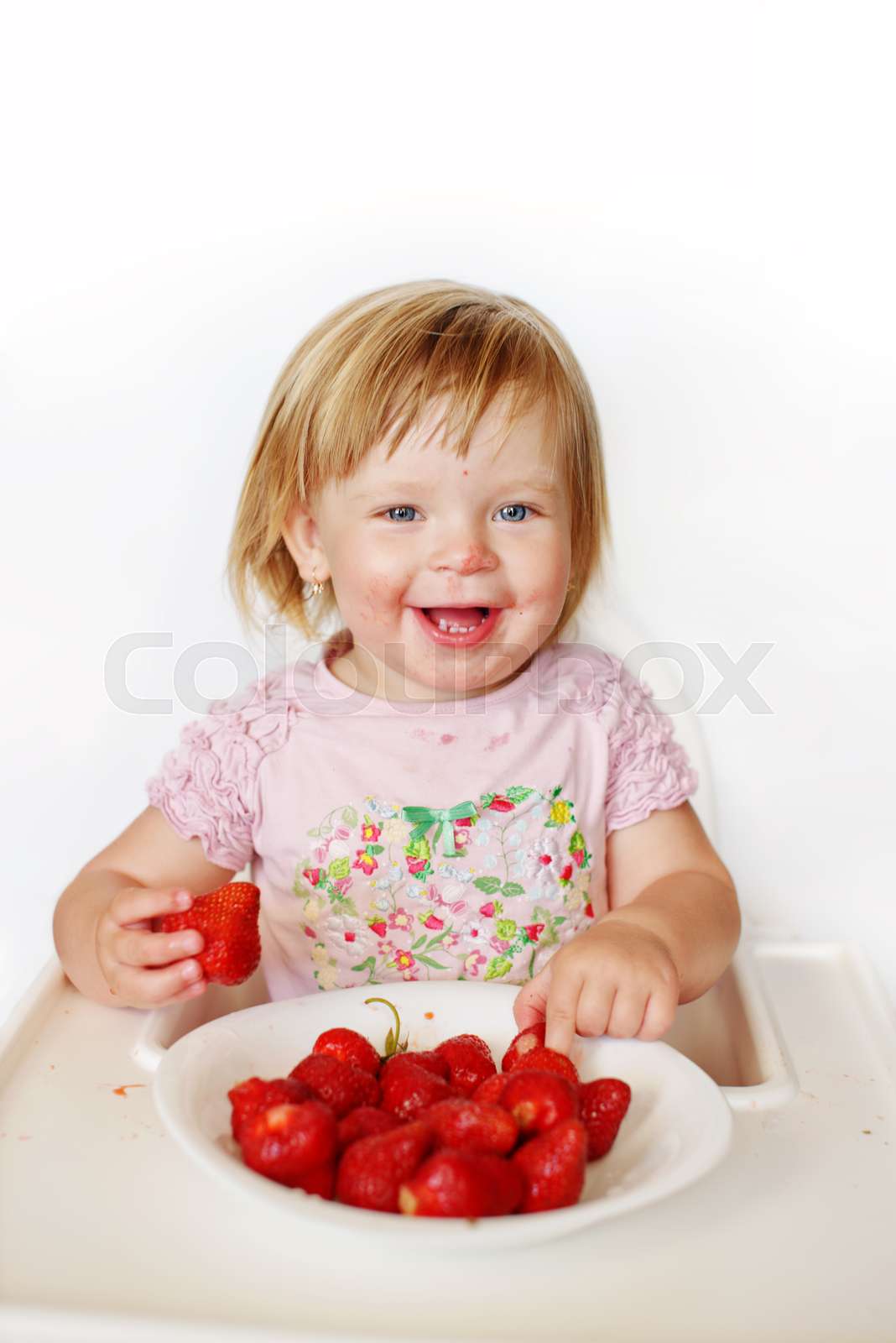 happy baby eating strawberry | Stock image | Colourbox