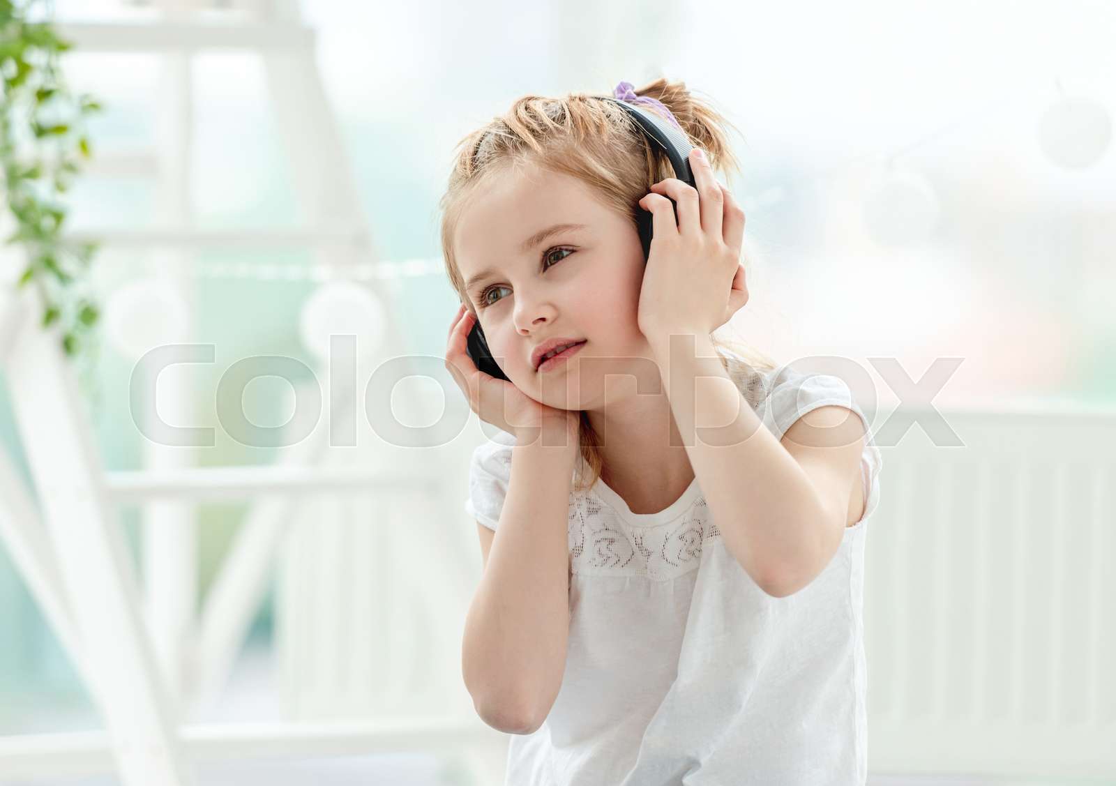 Beautiful little girl wearing headphones | Stock image | Colourbox