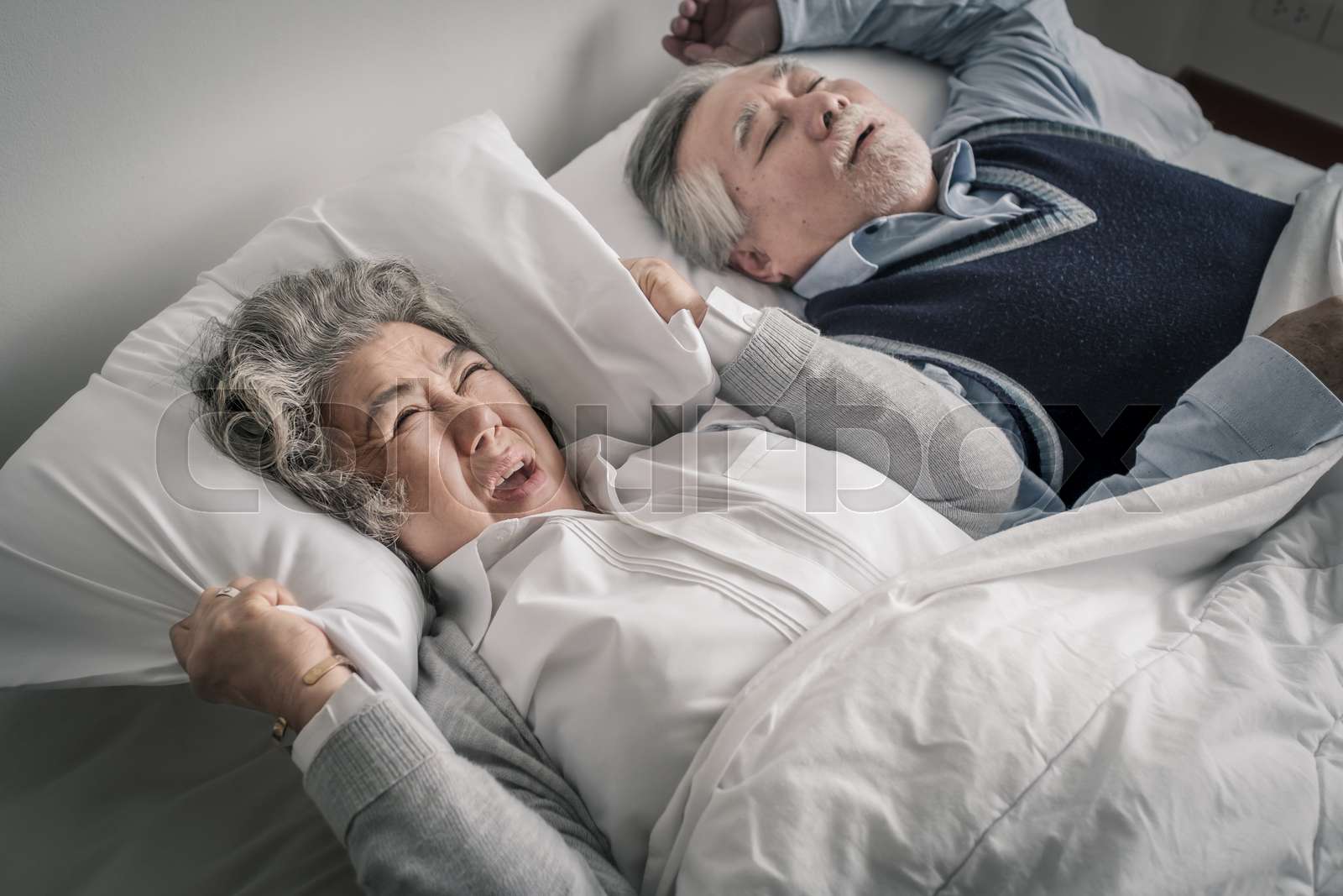 elderly couple caucasian senior woman and man sleep on bed and snoring ...