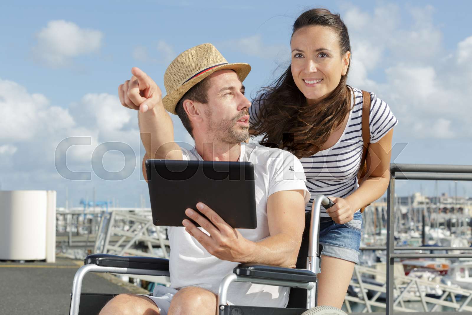 man in wheelchair pointing into distance | Stock image | Colourbox