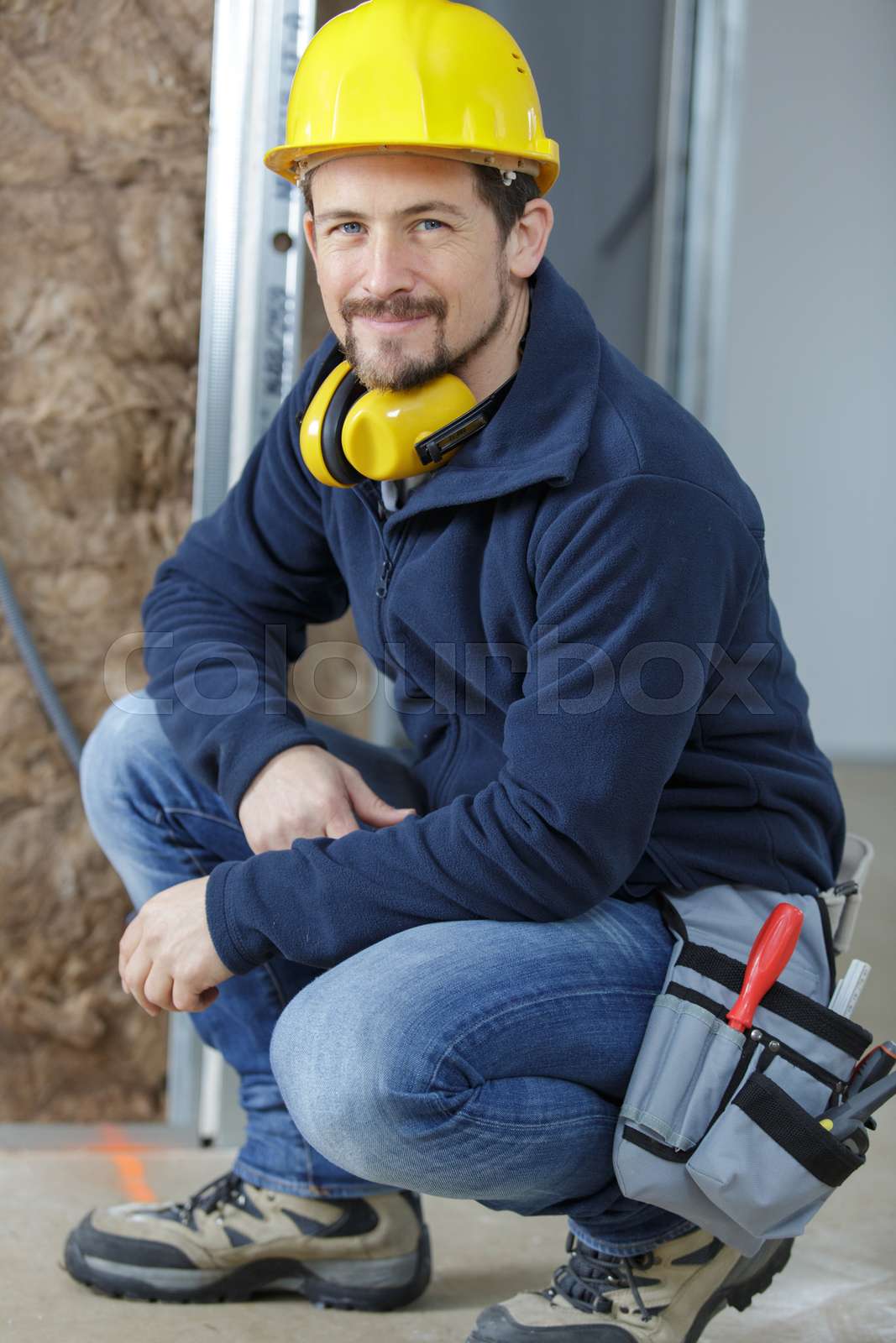 man wearing ear muff smiling close-up | Stock image | Colourbox