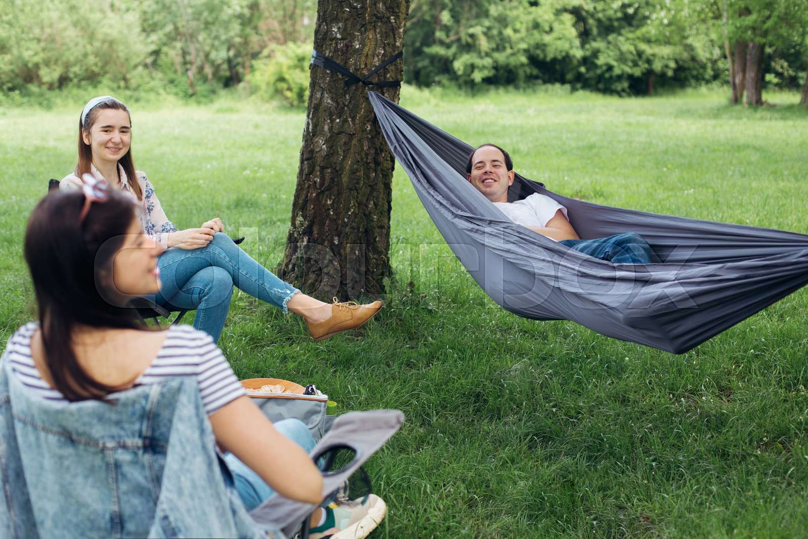 Social distancing. Small group of people enjoying conversation at ...