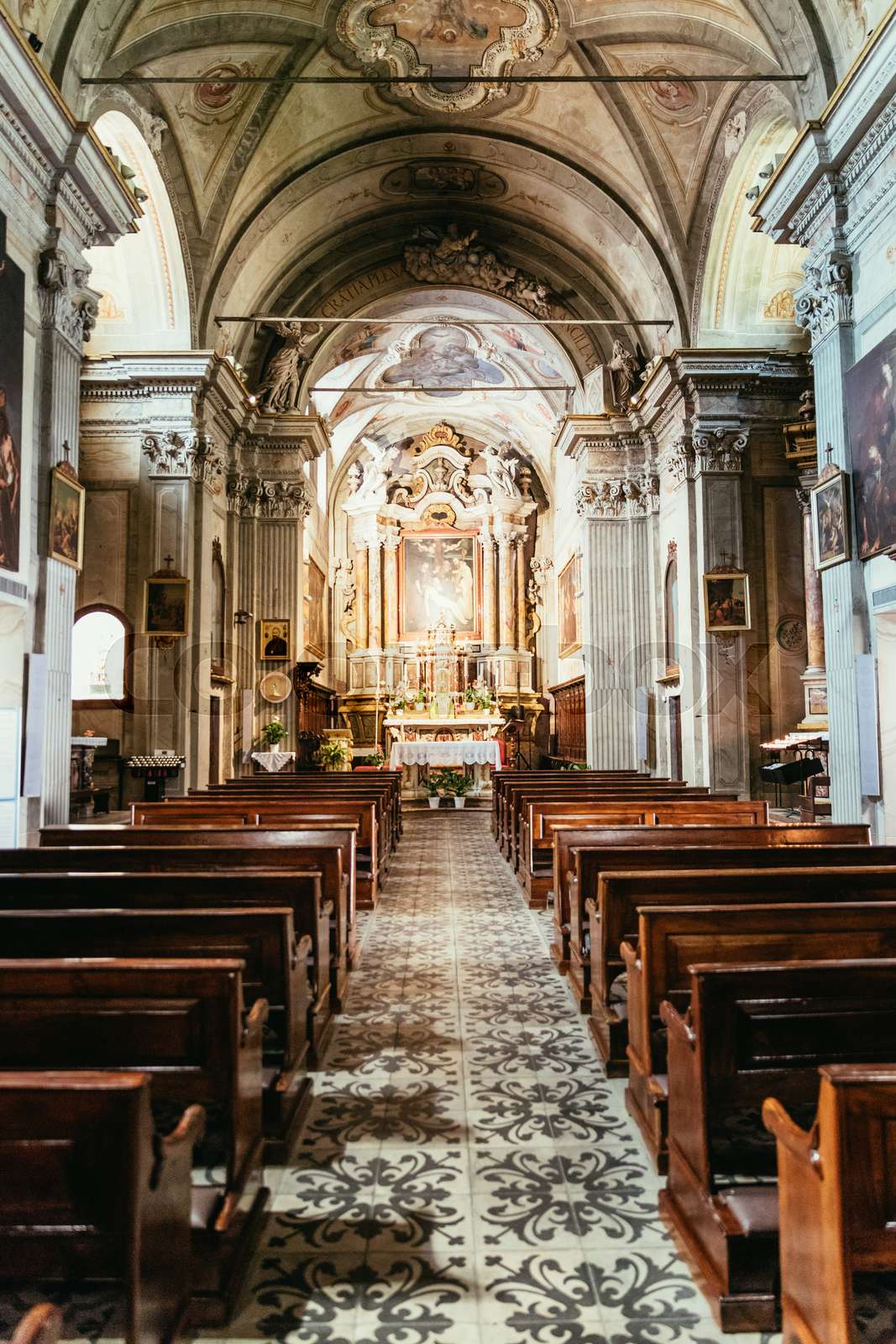 Historic catholic church: Wooden pews in a row and altar width crucifix ...