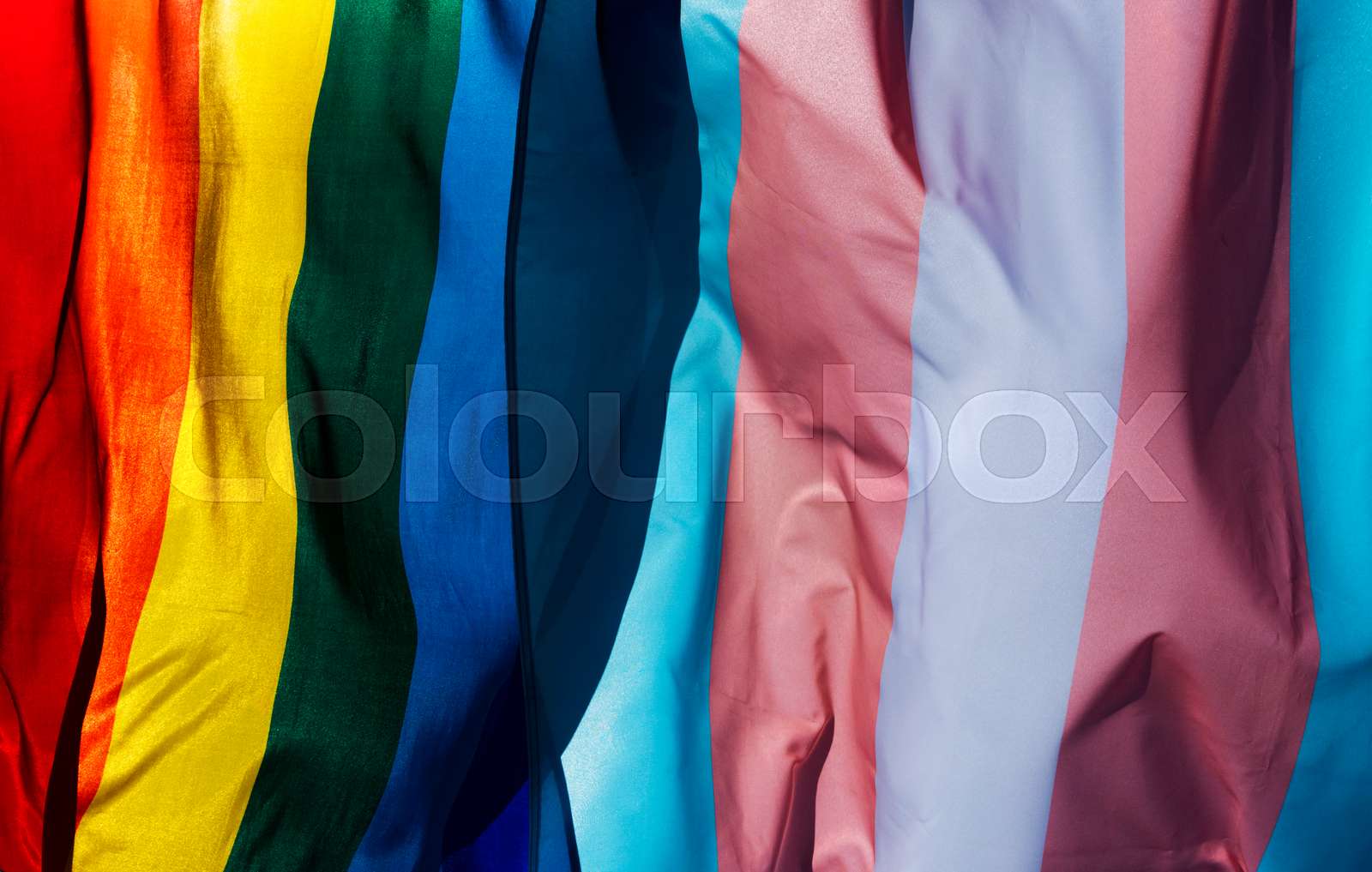 gay and transgender pride flags waving on the sky | Stock image | Colourbox