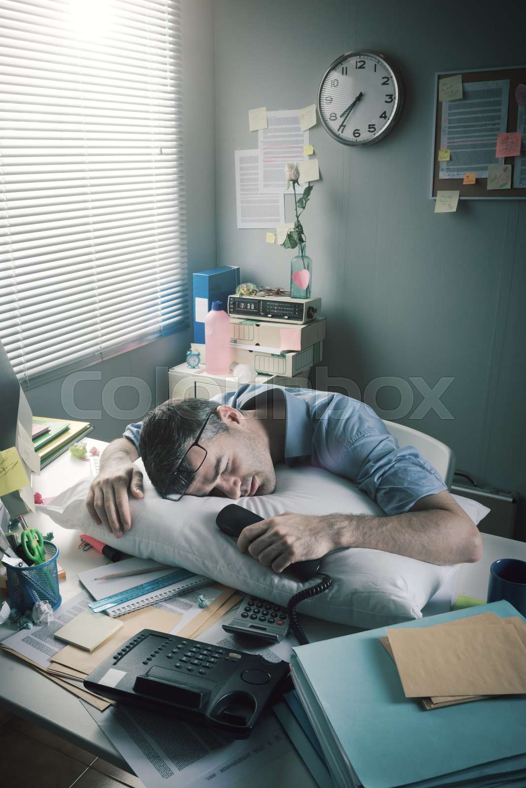 Businessman sleeping in the office overnight | Stock image | Colourbox