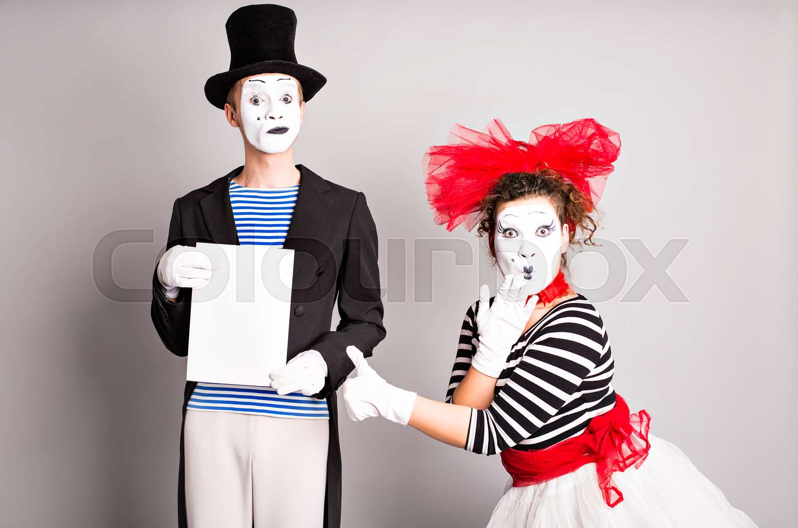 Two mimes with a sign for advertising | Stock image | Colourbox