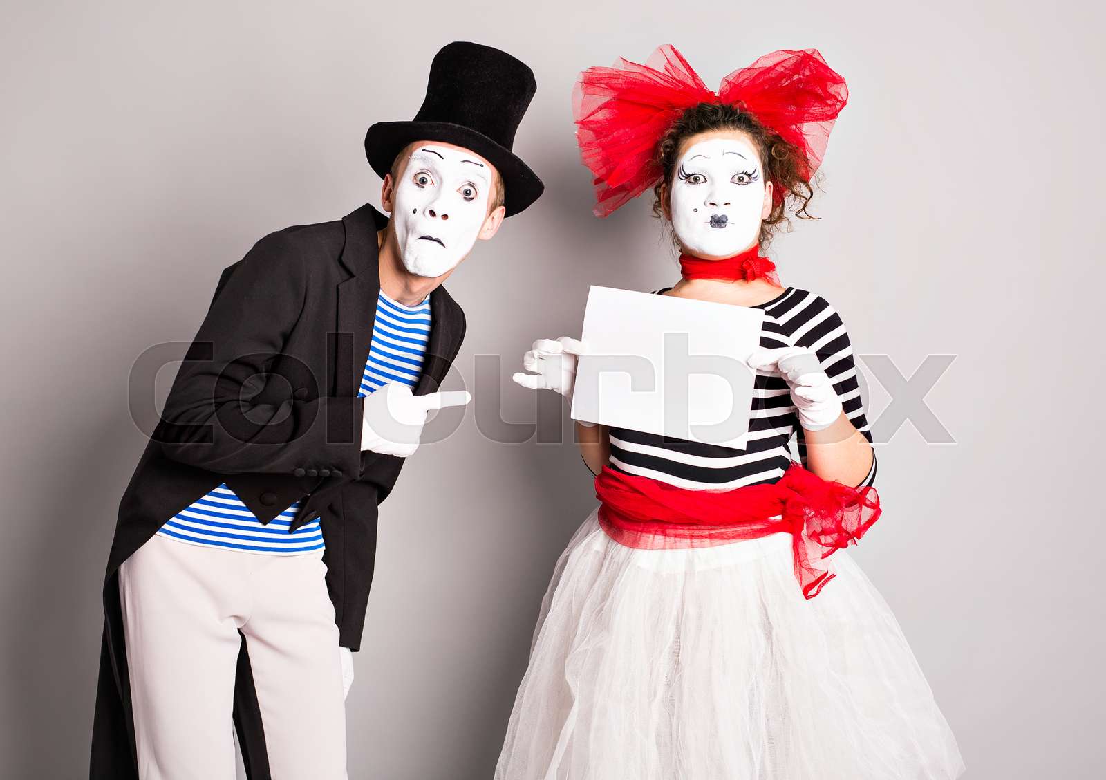 Two mimes with a sign for advertising | Stock image | Colourbox