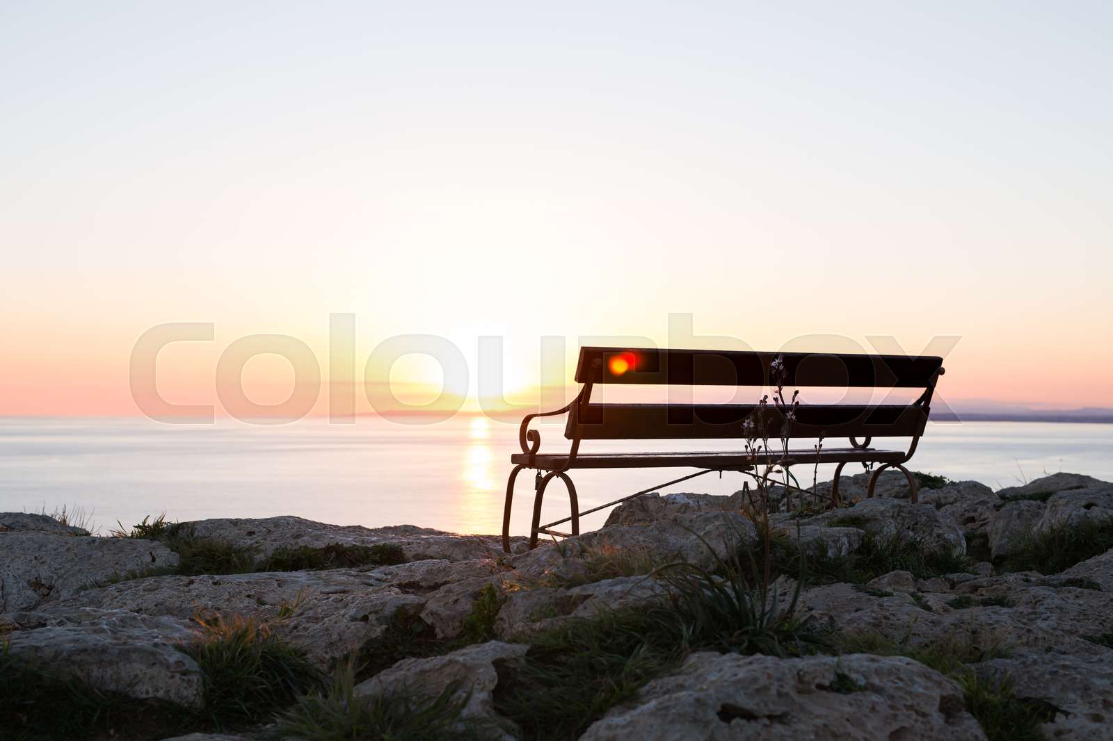 Sunset beach and bench | Stock image | Colourbox