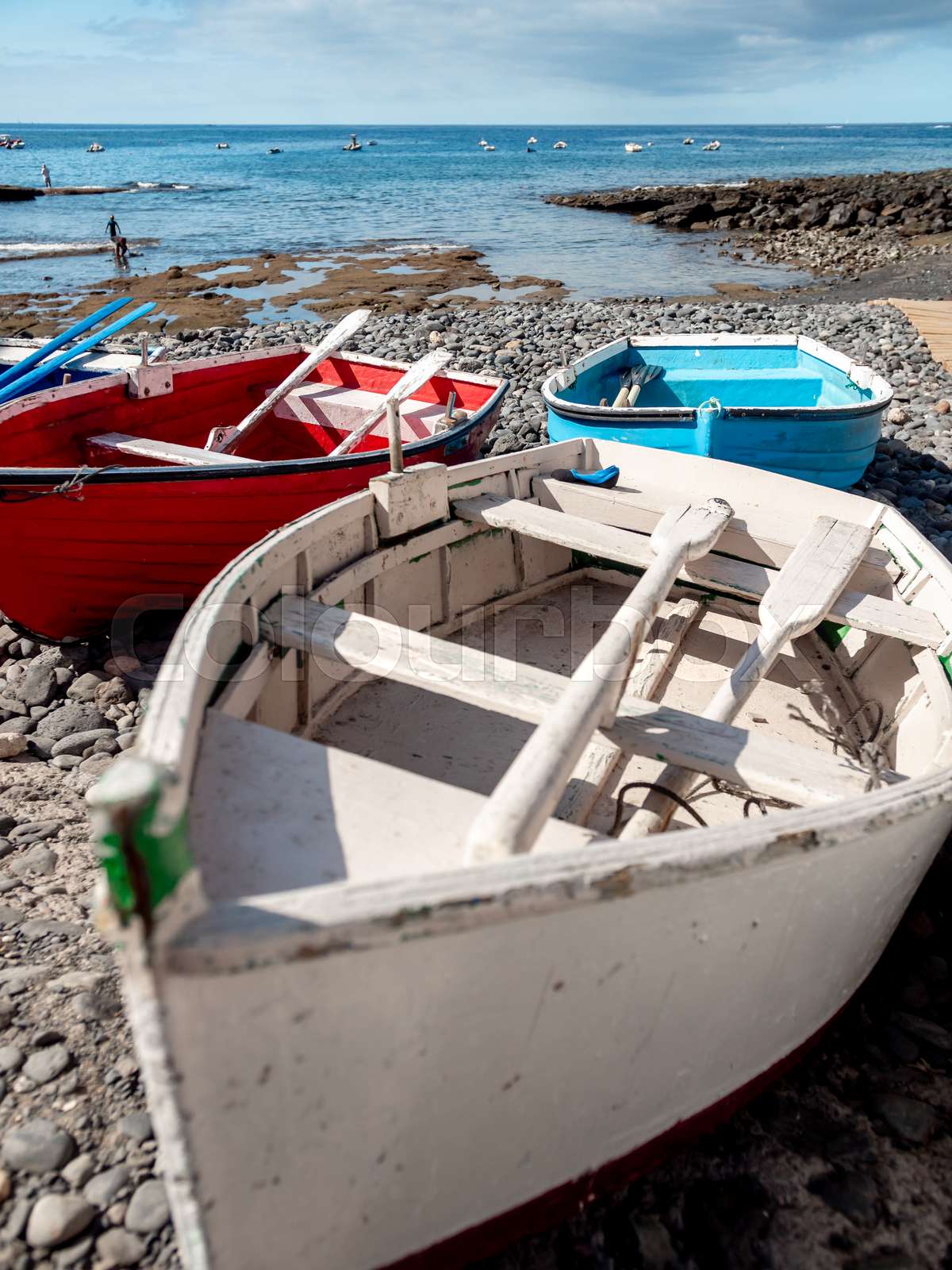 Beautiful image of rocky ocean shore and old wooden rowing boats at ...