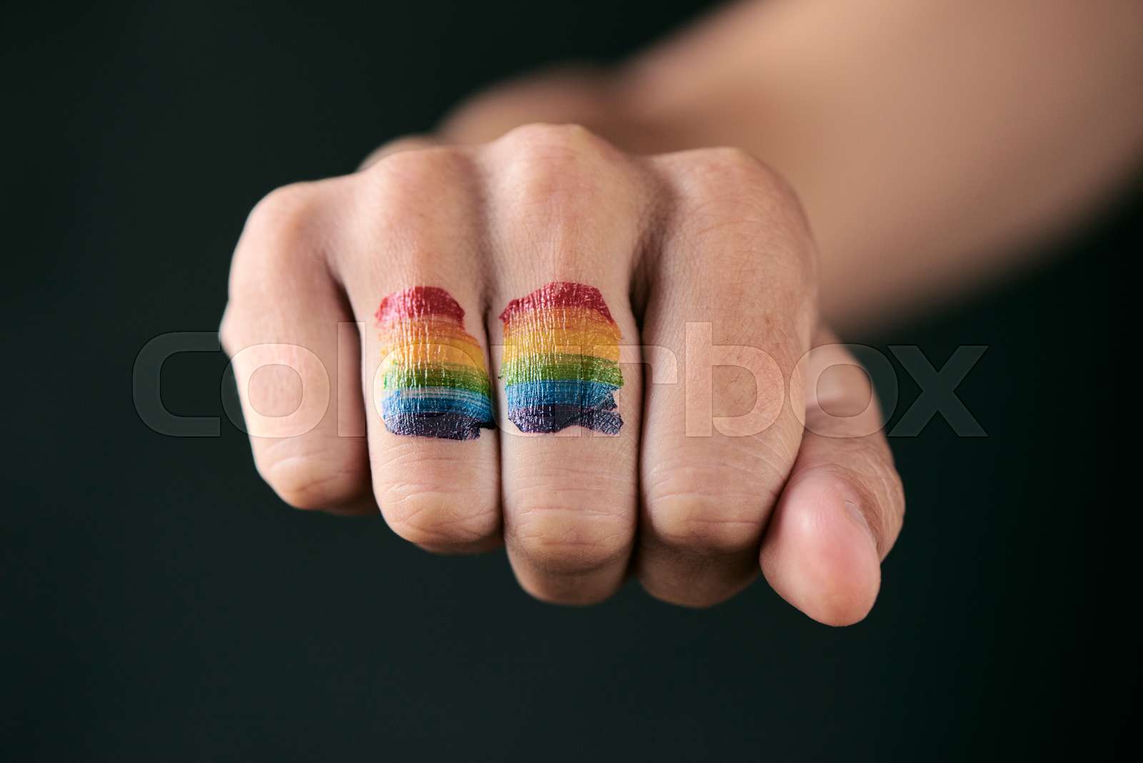 rainbow flag in the fist of a person | Stock image | Colourbox