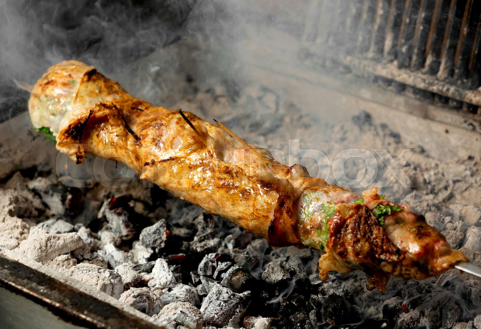 skewered kebab wrapped in fat cooked on charcoal | Stock image | Colourbox