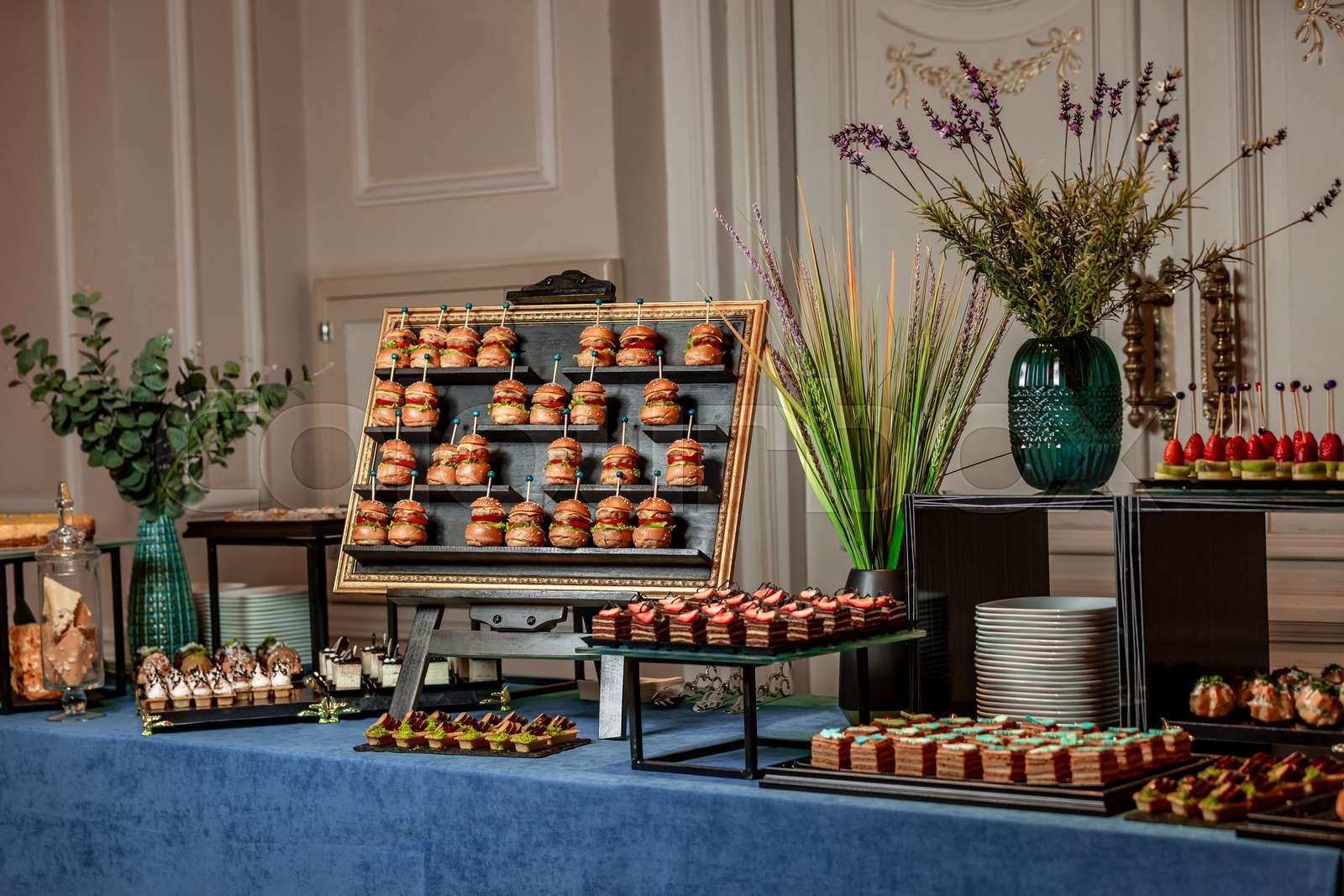 buffet table of mini cakes and burgers | Stock image | Colourbox