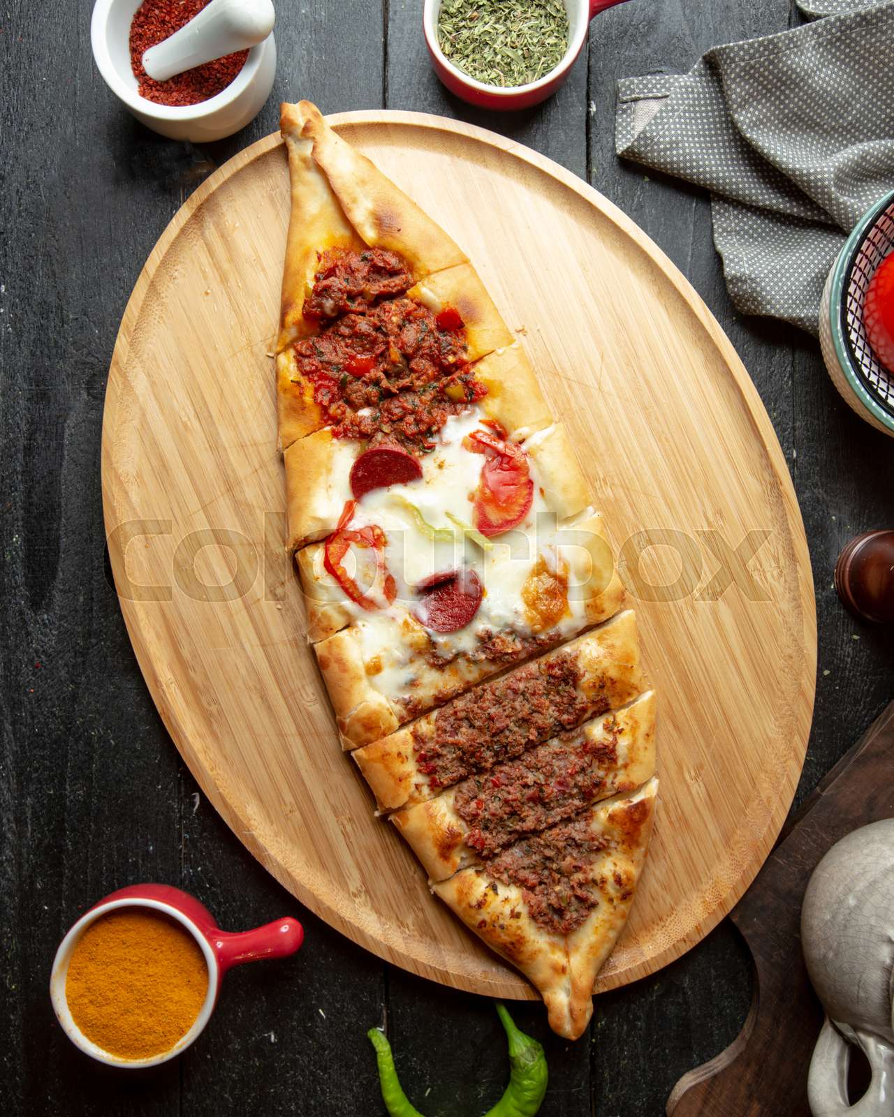 Mixed pide with minced meat pepperoni cheese tomato and bell peppers ...