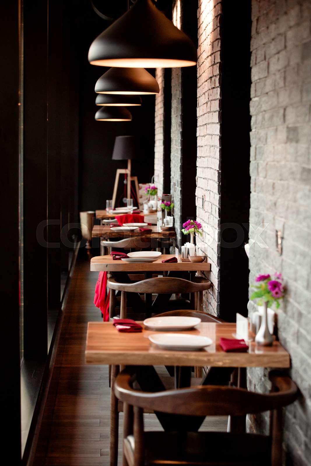 A restaurant corridor with small two people tables | Stock image ...