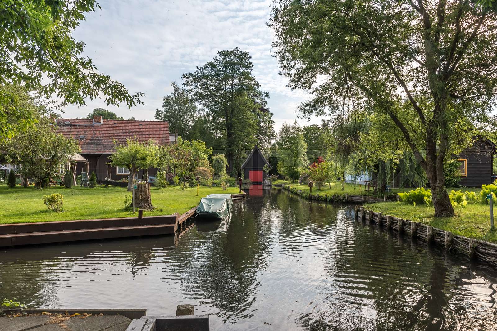 House at a crossover of water canals in biosphere reserve Spree forest ...