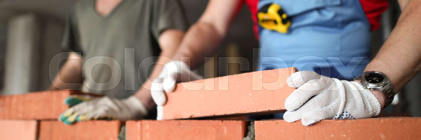 Bricklayers st construction site laying bricks | Stock image | Colourbox