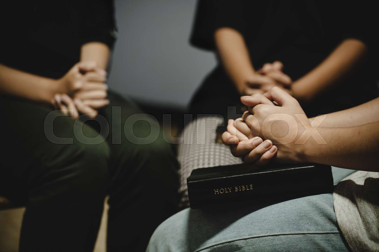 Three people pray and praising God together | Stock image | Colourbox