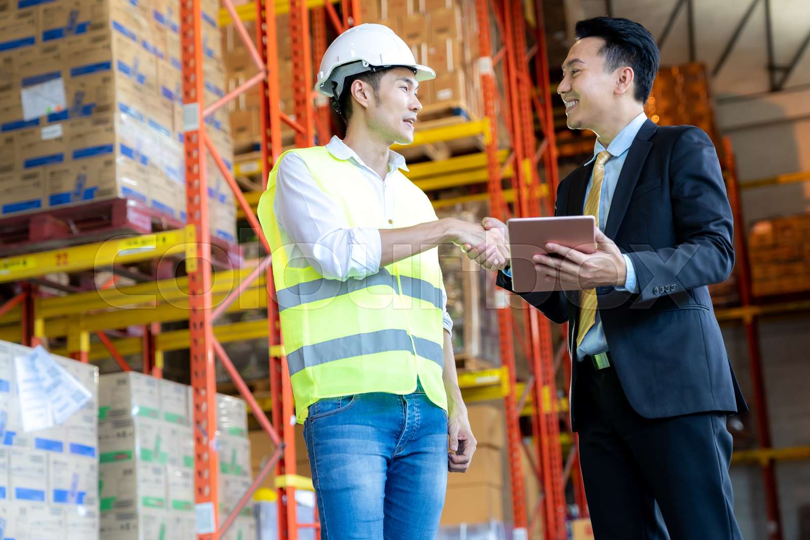 Asian warehouse owner shake hand with warehouse engineer. | Stock image ...