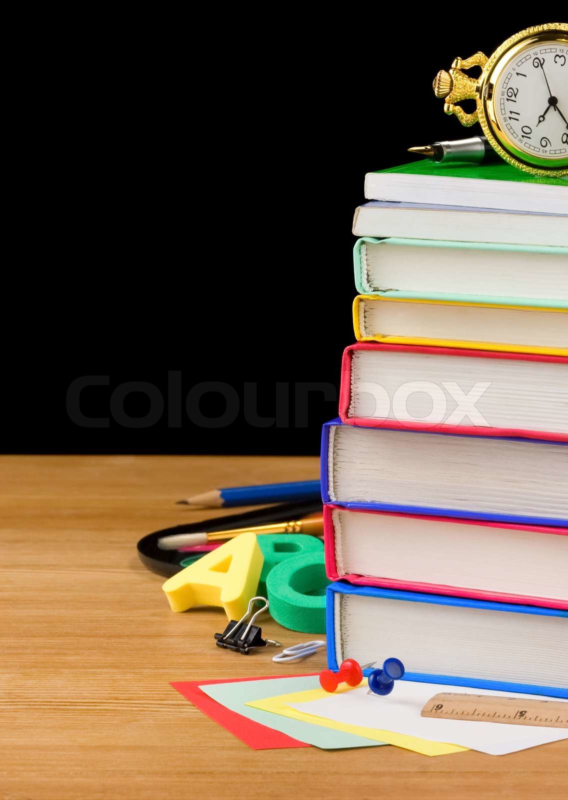 pile of books and school supplies isolated on black | Stock image ...