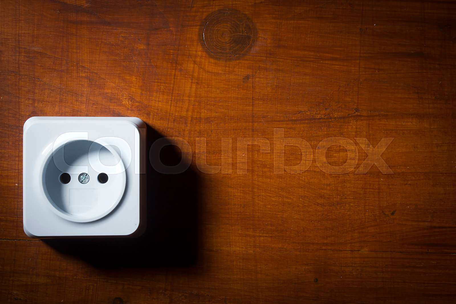 Electrical outlet on wooden wall | Stock image | Colourbox