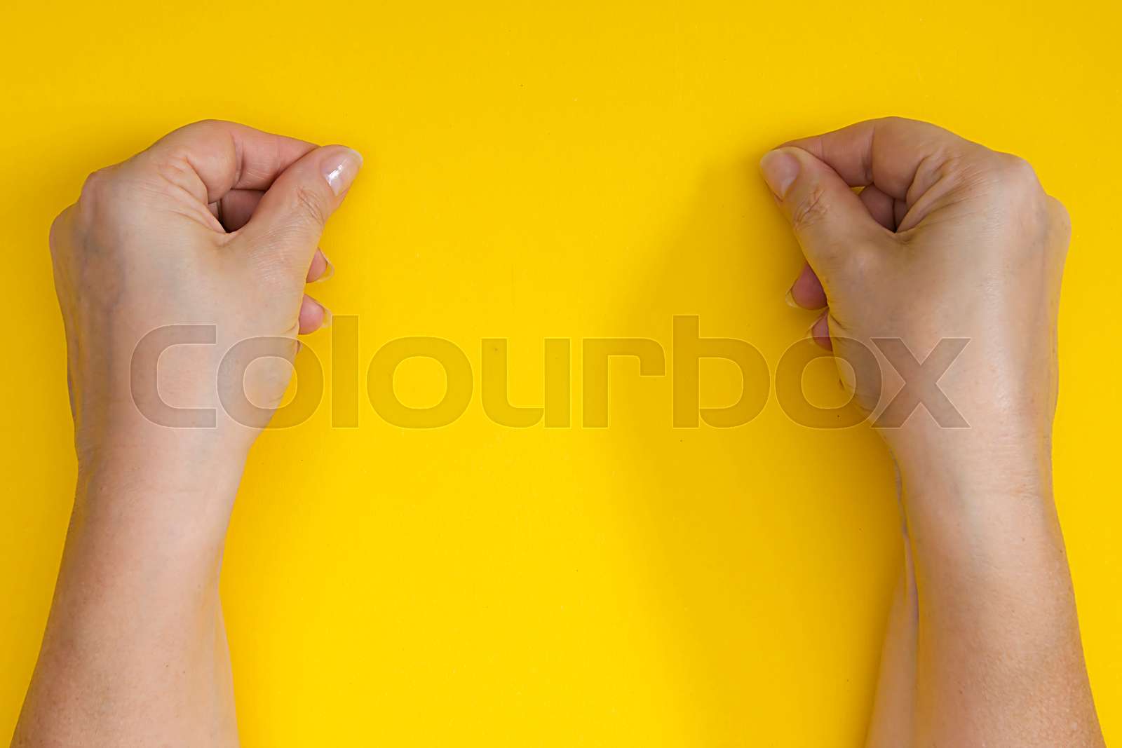 Hands with clenched fingers in a pinch | Stock image | Colourbox